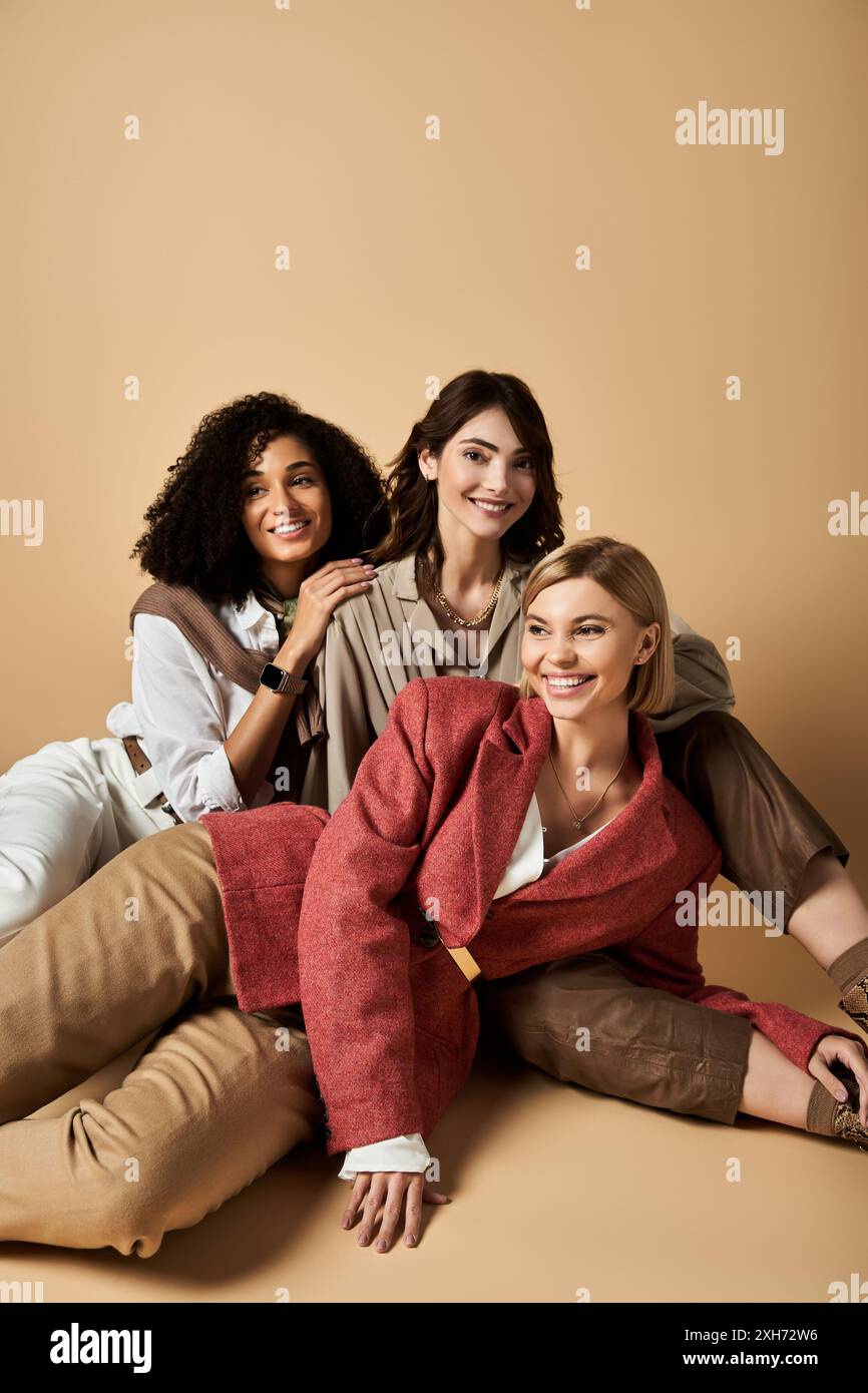 Beautiful multicultural women in stylish attire sit together ...