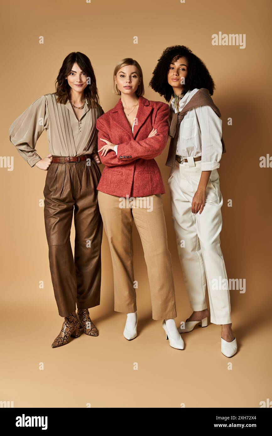 Three young, beautiful, multicultural women in stylish attire stand ...