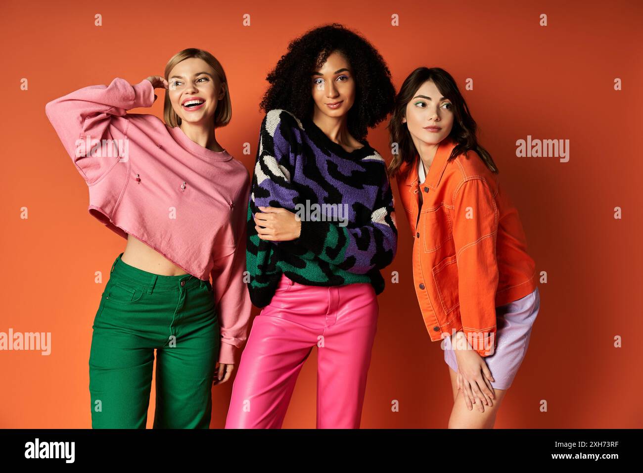 A group of young, beautiful women in vibrant clothes stand together ...