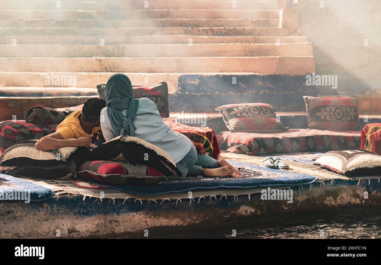 Romantic Muslim couple in love relaxing on Cushions in Setti Fatma ...