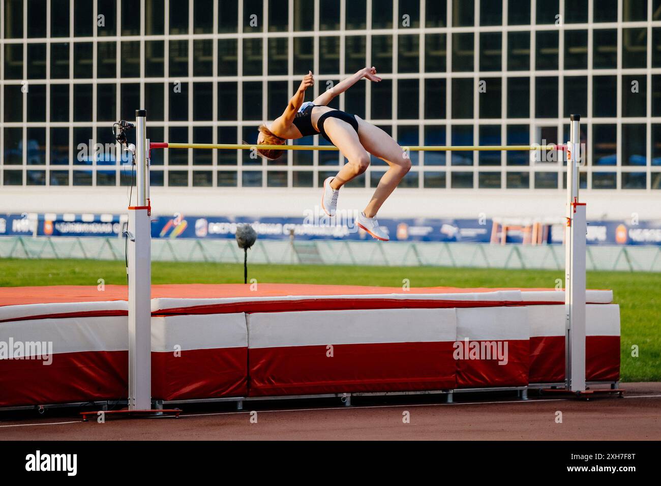 successful attempt high jump female athlete at athletics competition ...