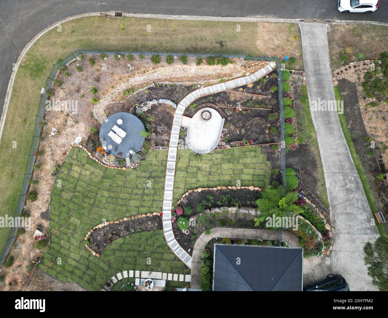 An aerial view of a landscaped garden with pathways, greenery, and a ...