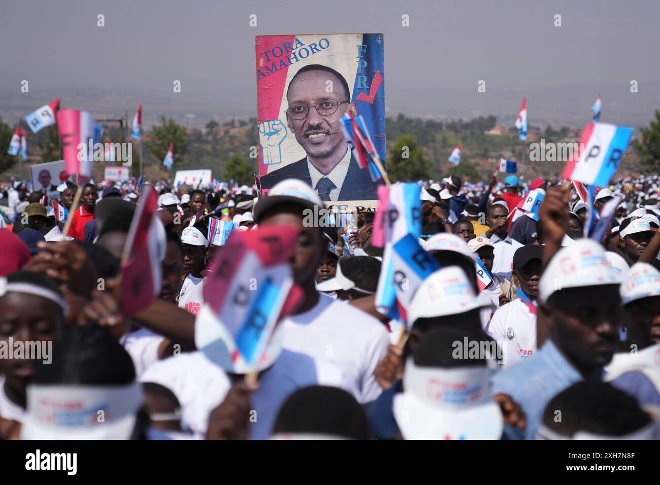 Supporters of Rwanda's President Paul Kagame, portrait center, attend ...