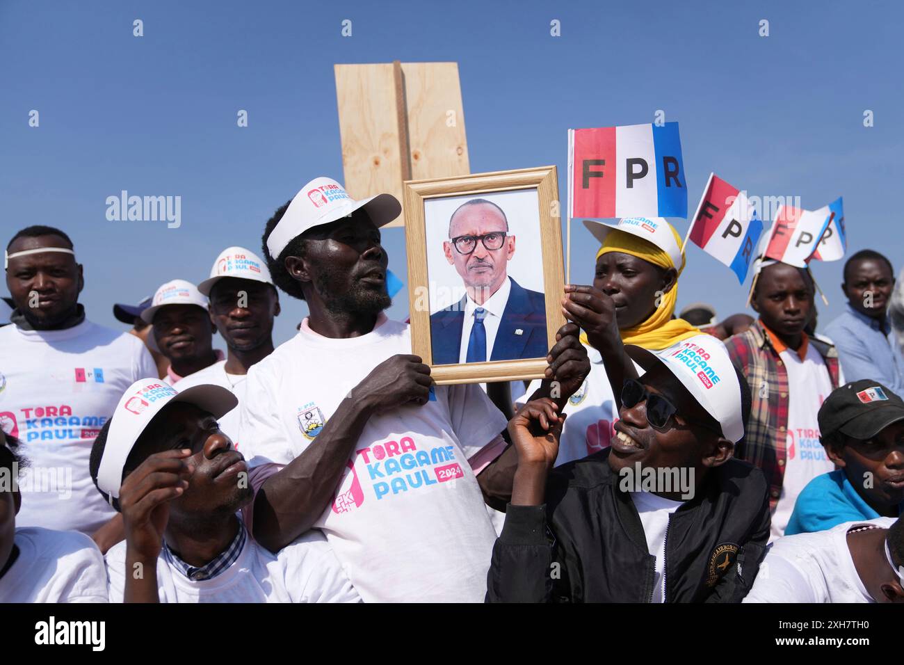 Supporters of Rwanda's President Paul Kagame, portrait center, attend ...