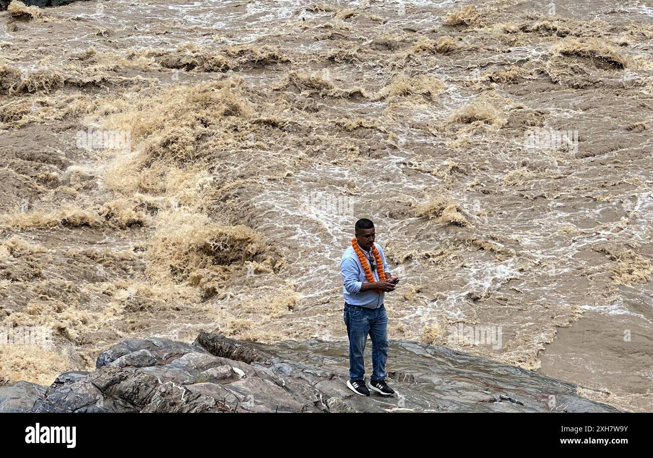 July 12, 2024: A man takes photos of swollen Bagmati river after heavy rainfall at Chovar in ...