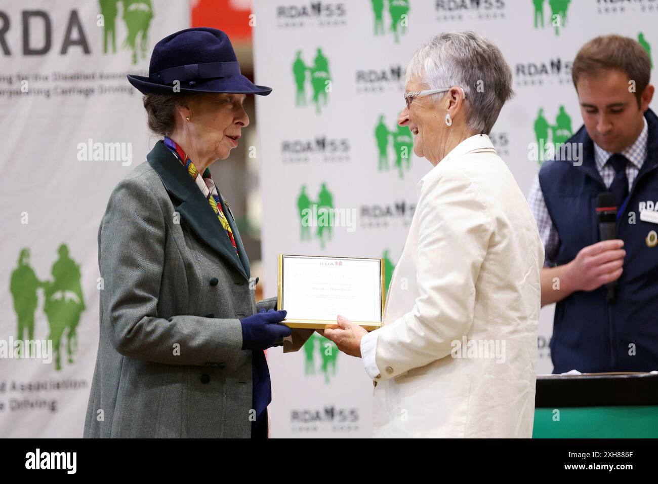 The Princess Royal presents an award during the Riding for the Disabled ...