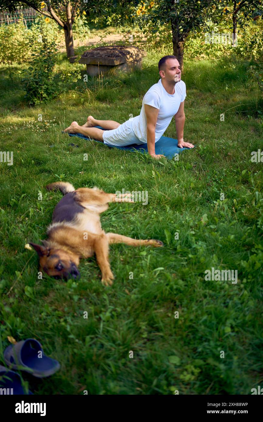 Man somatic exercises dog in hi-res stock photography and images - Alamy