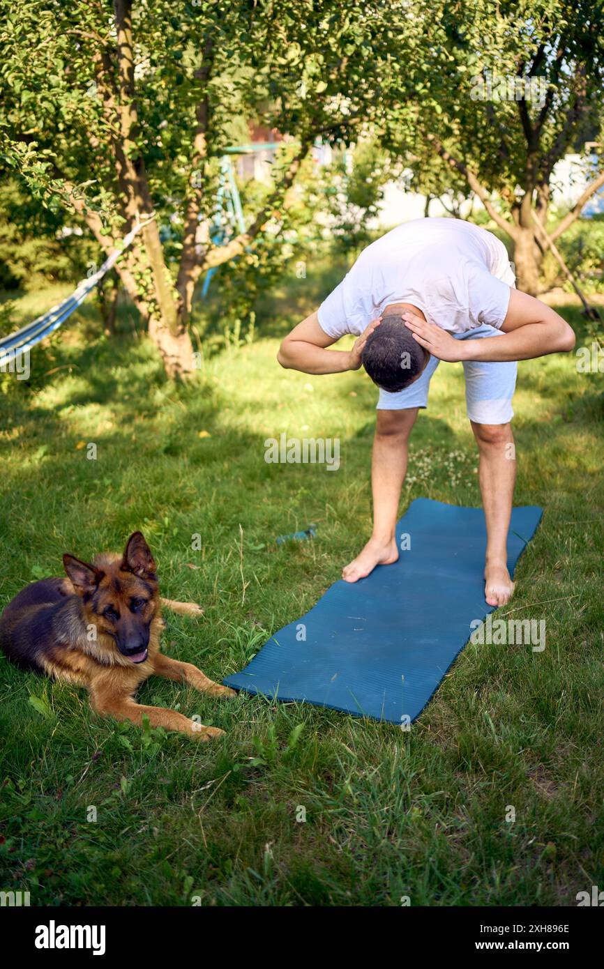Man somatic exercises dog in hi-res stock photography and images - Alamy