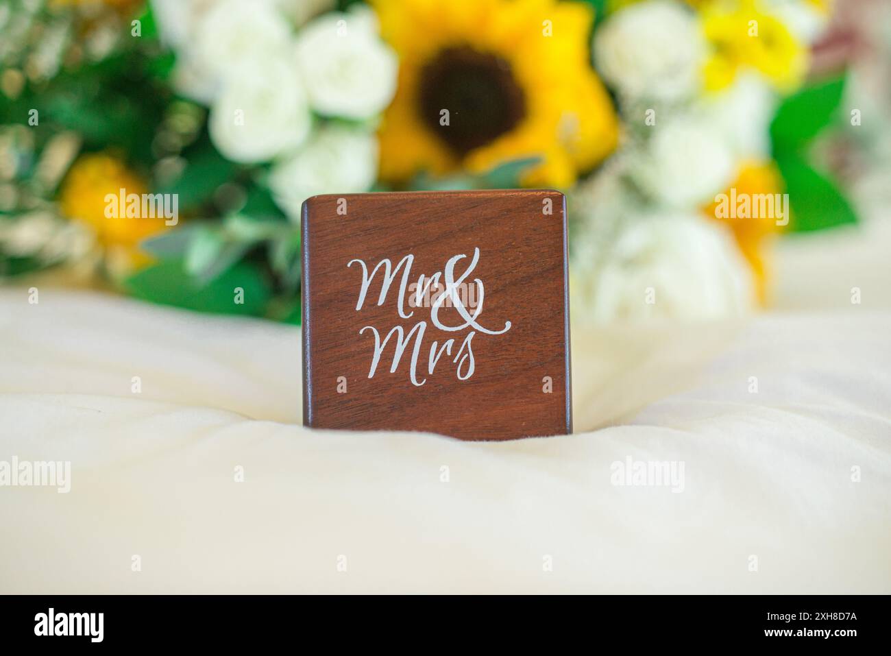 Wood block with white text that reads"mr&Mrs, on white surface with ...