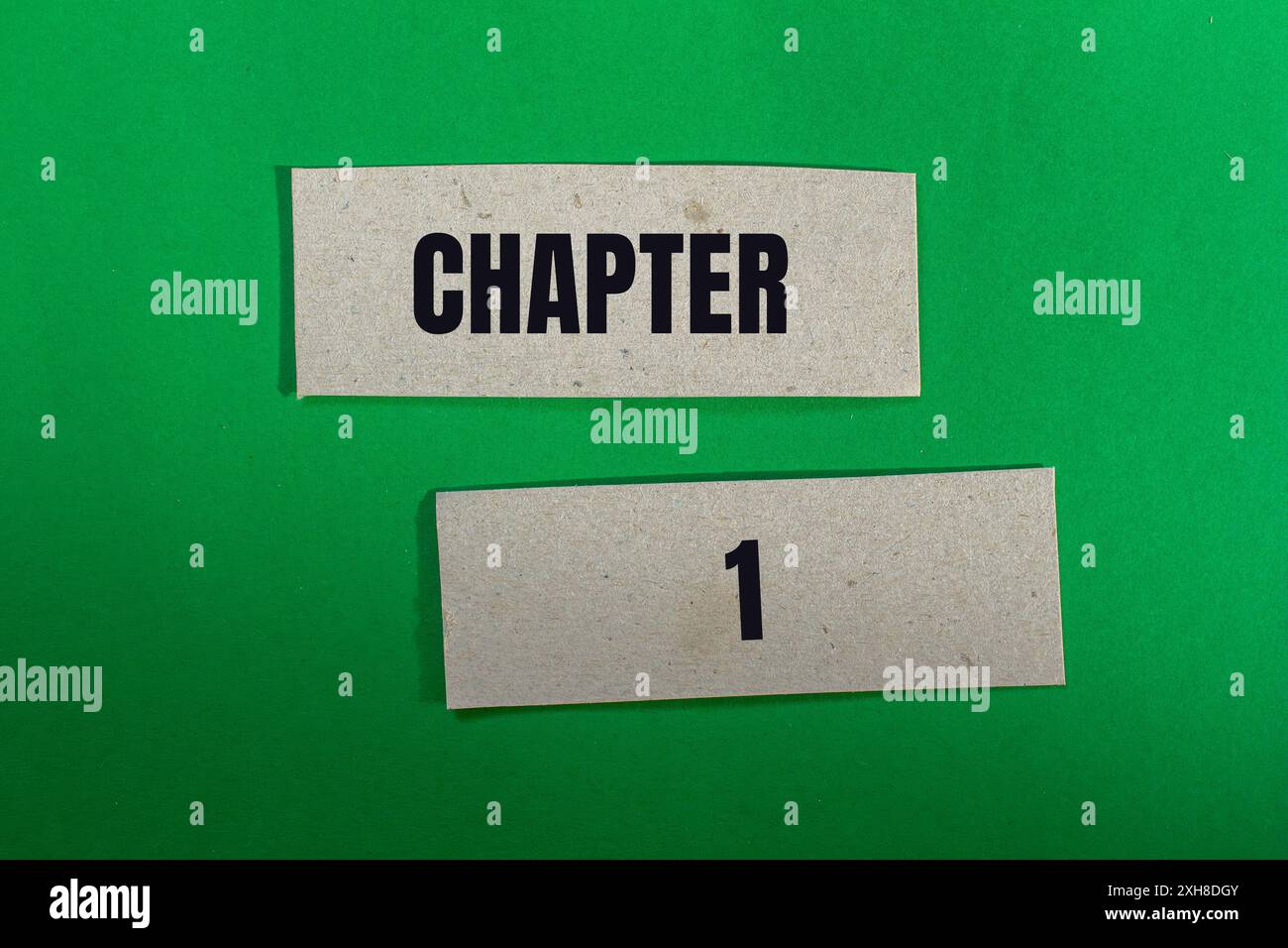 Chapter 1 message written on paper pieces with green background ...
