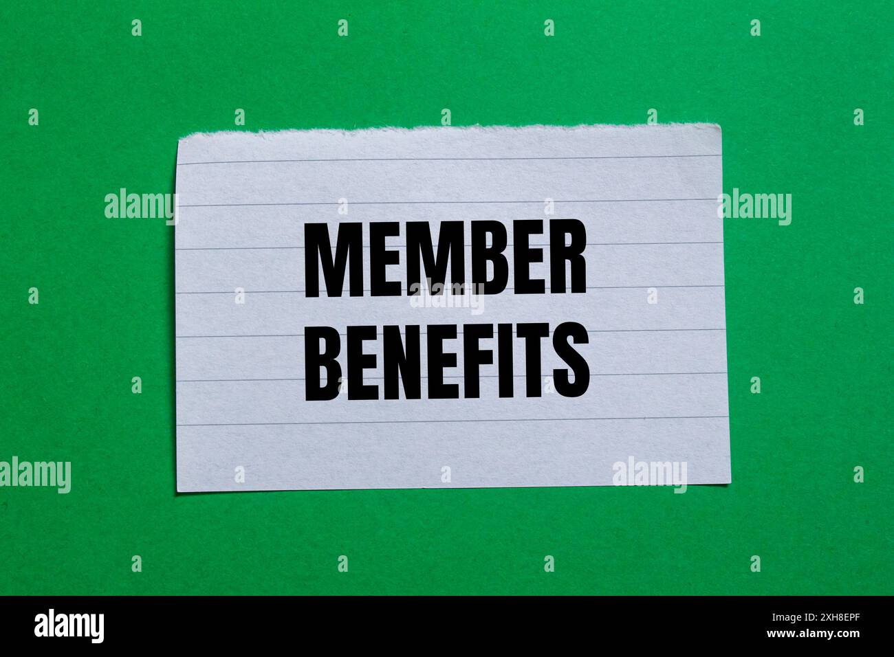 Member benefits message written on ripped torn paper piece with green background. Conceptual ...