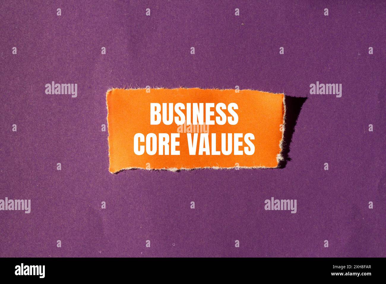 Business core values message written on ripped torn orange paper piece ...