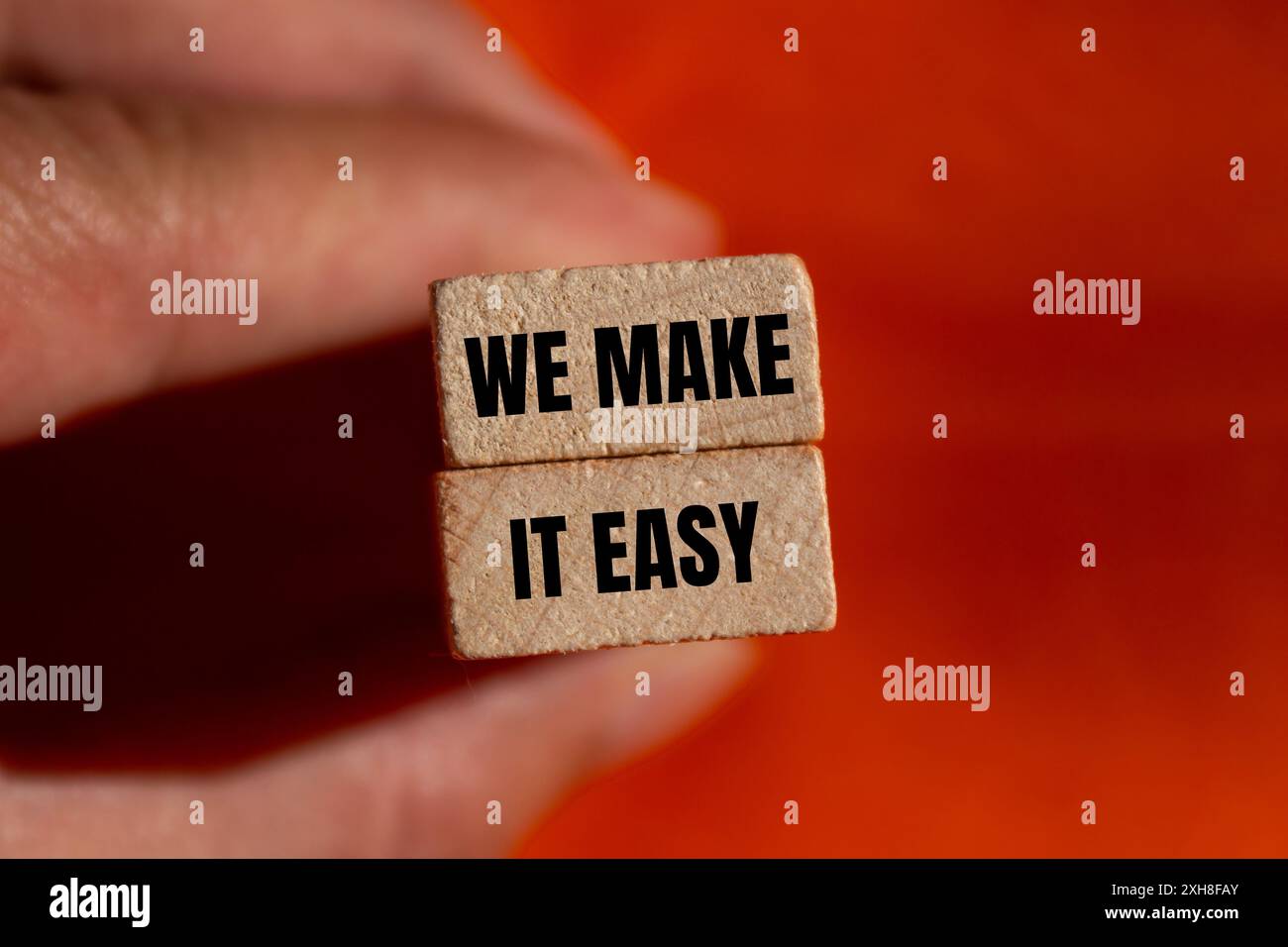 We make it easy message written on wooden blocks with orange background. Conceptual we make it ...