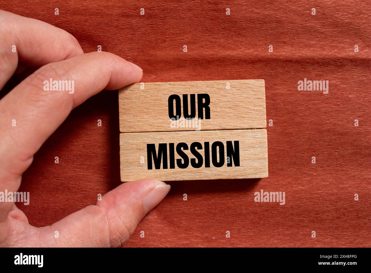 Our mission message written on wooden blocks with brown background ...