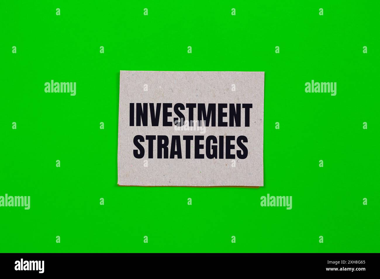 Investment strategies message written on paper piece with green ...