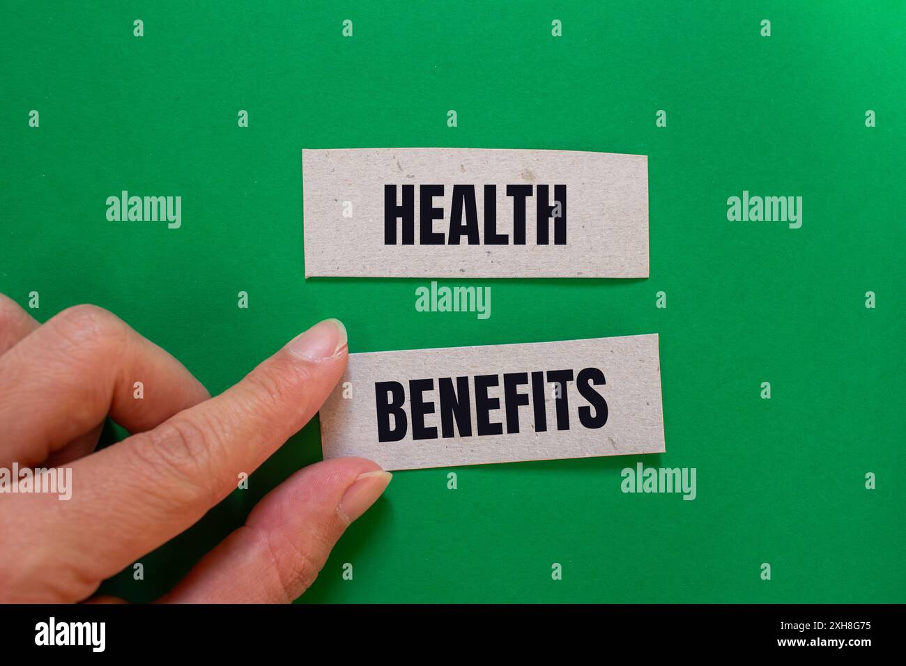 Health benefits message written on paper pieces with green background ...