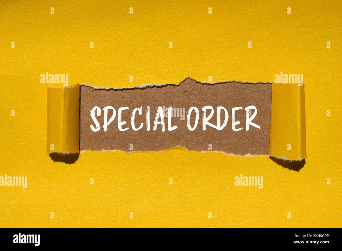 Special order message written on ripped torn yellow paper with brown background. Conceptual ...