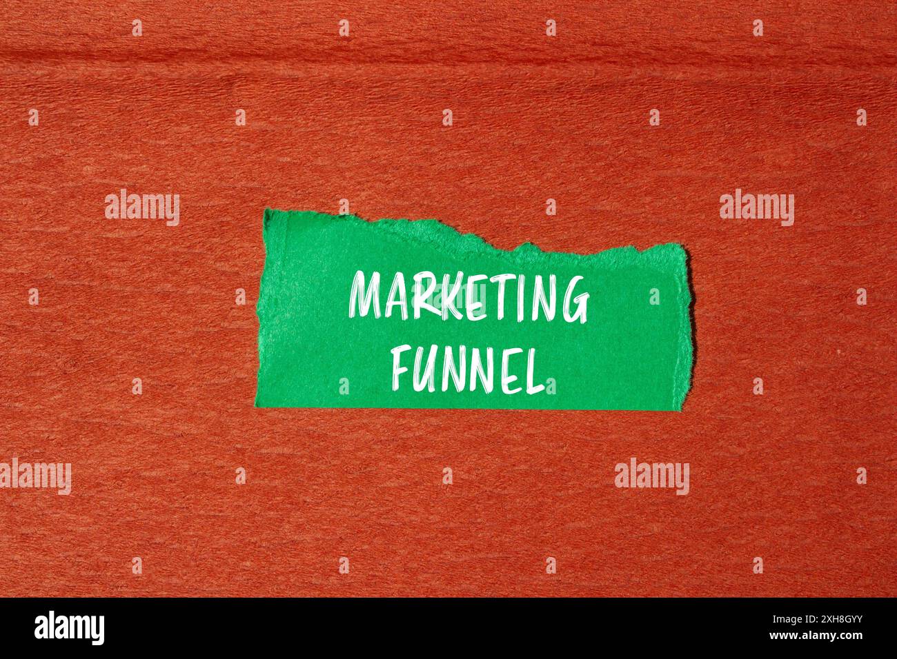 Marketing funnel message written on ripped torn green paper piece with ...