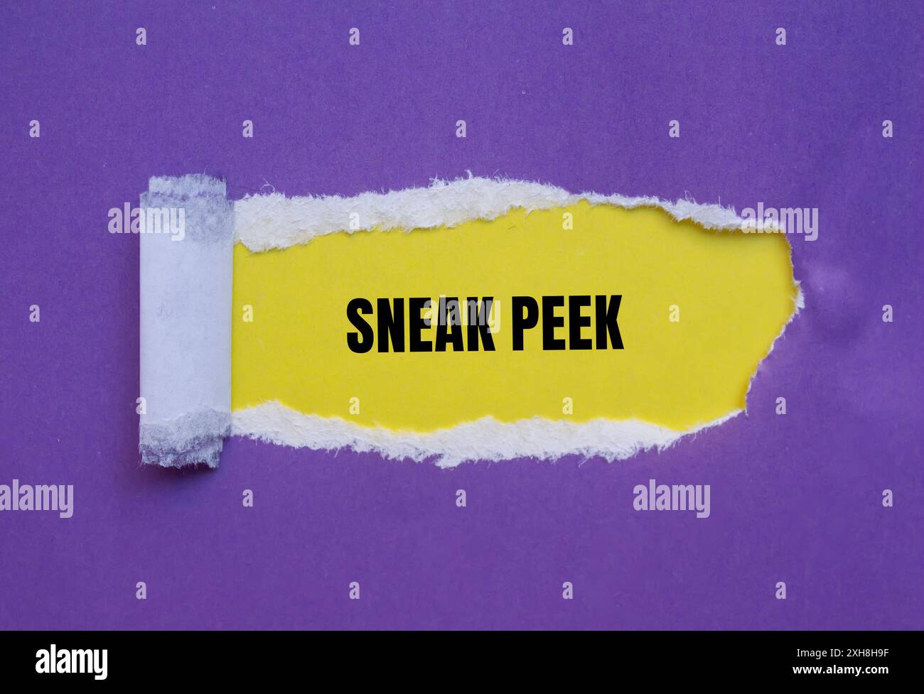 Sneak peek message written on ripped torn purple paper with yellow ...