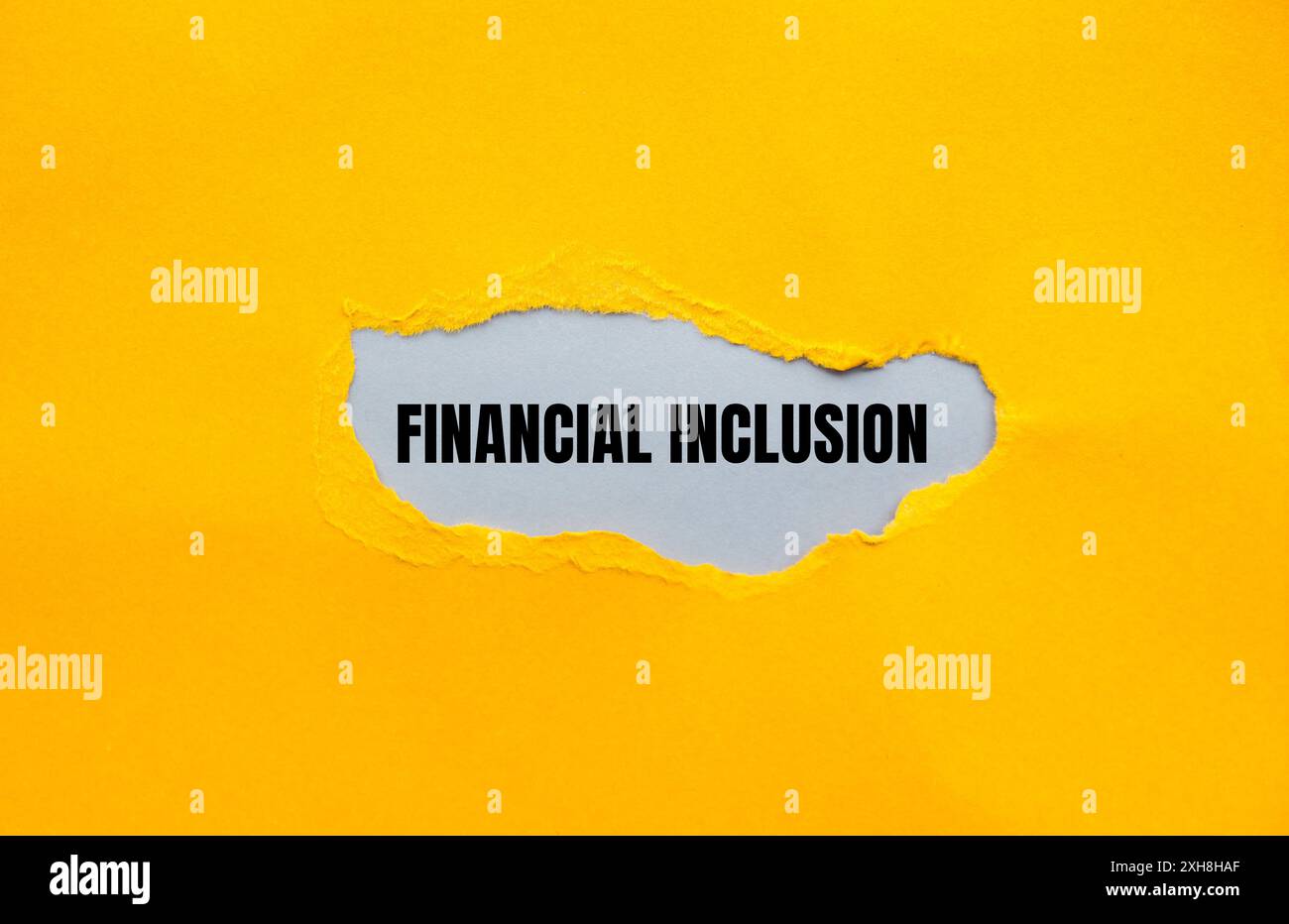 Financial inclusion message written on ripped yellow torn paper with ...
