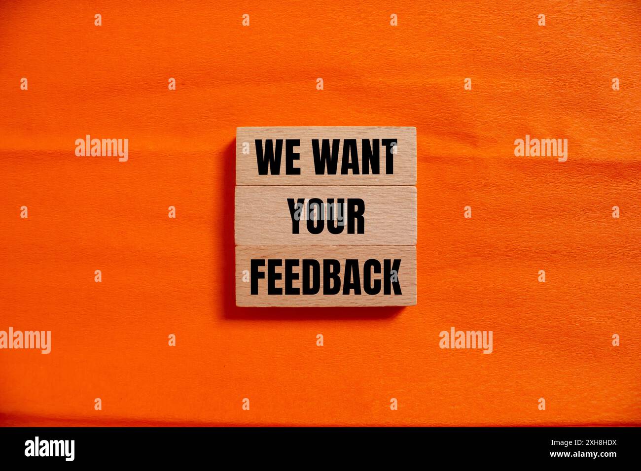 We want your feedback message written on wooden blocks with orange ...