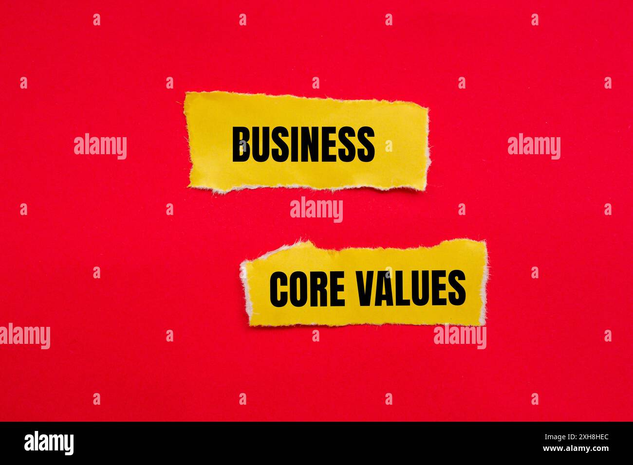 Business core values message written on ripped torn yellow paper pieces ...
