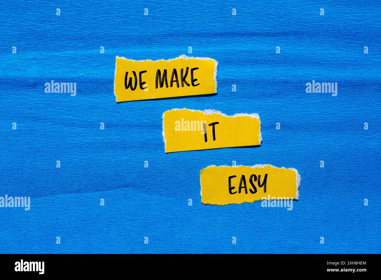 We make it easy message written on ripped torn yellow paper pieces with ...