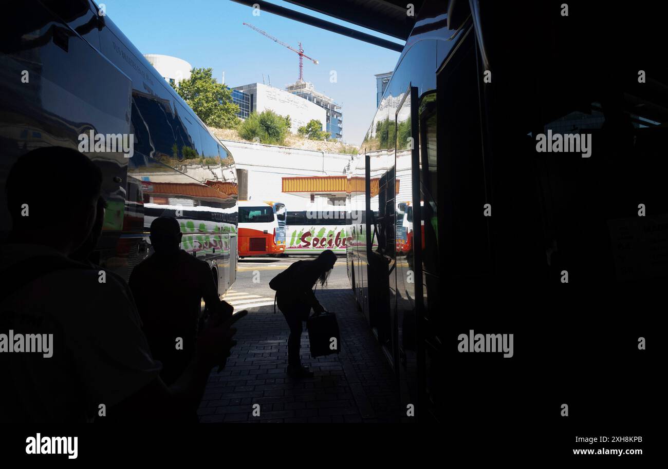 Several people at the bus docks to board a bus at the Méndez Álvaro bus ...