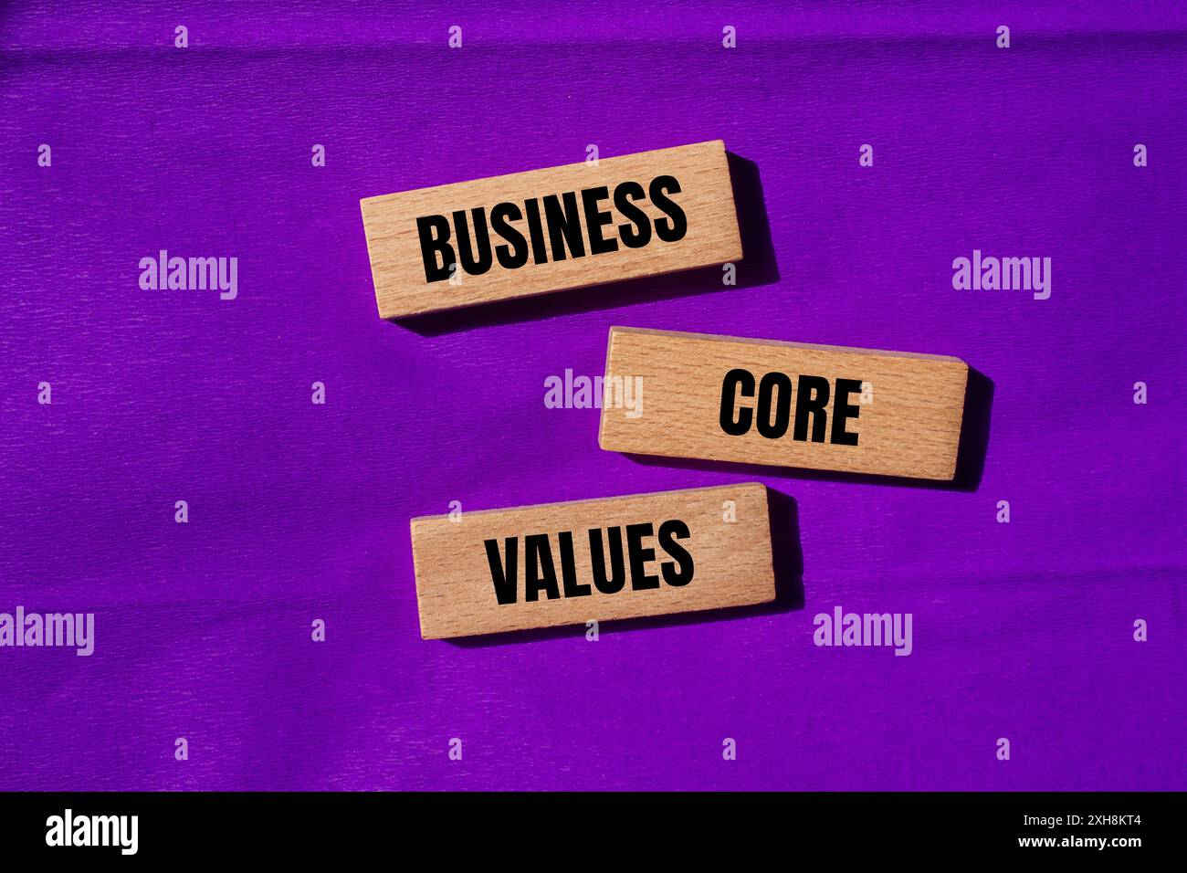 Business core values message written on wodoen blocks with purple ...