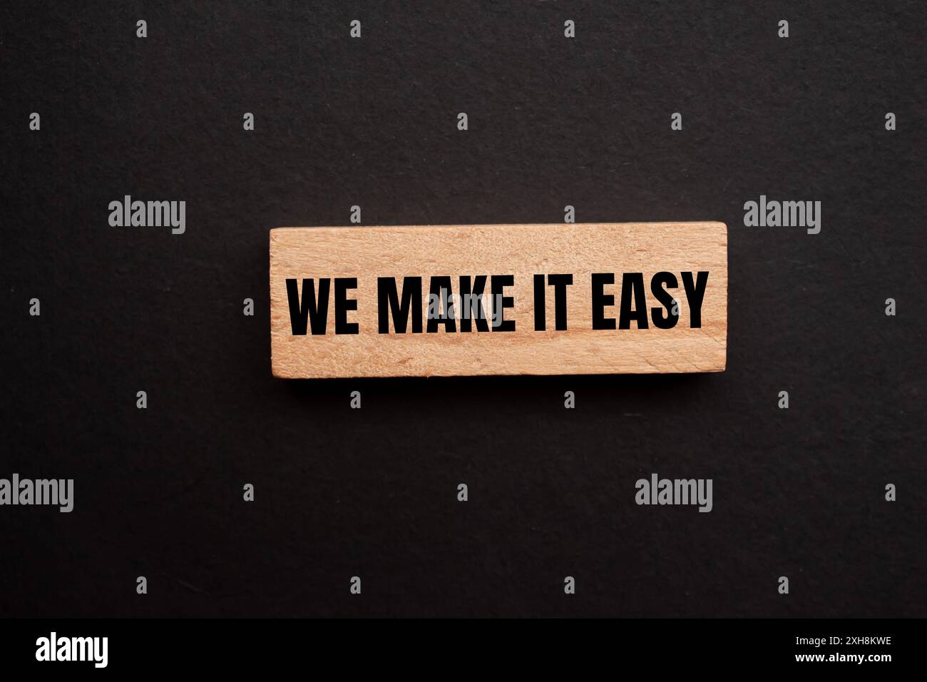 We make it easy message written on single wooden block with black ...