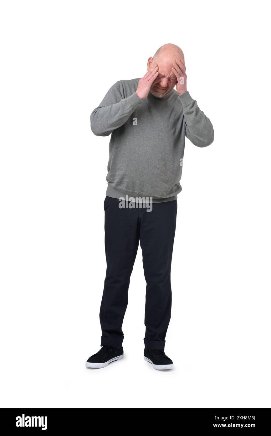 front view of a full length portrait of a man in headache pain isolated ...