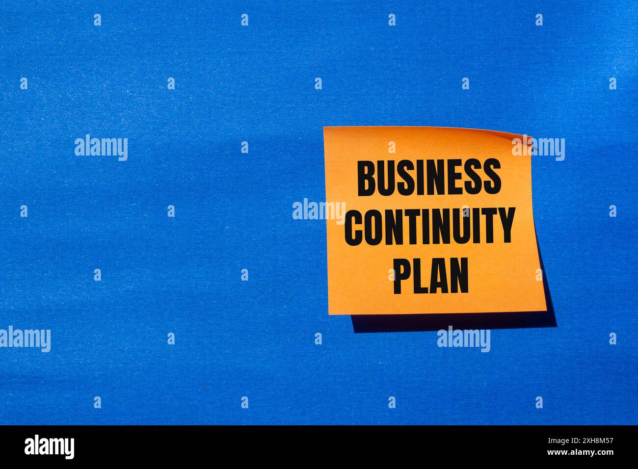 Business continuity plan messagewritten on orange paper with blue ... Business continuity plan messagewritten on orange paper with blue ...