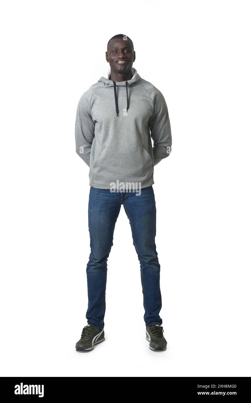 front view portrait of an african man standing with his hands behind ...