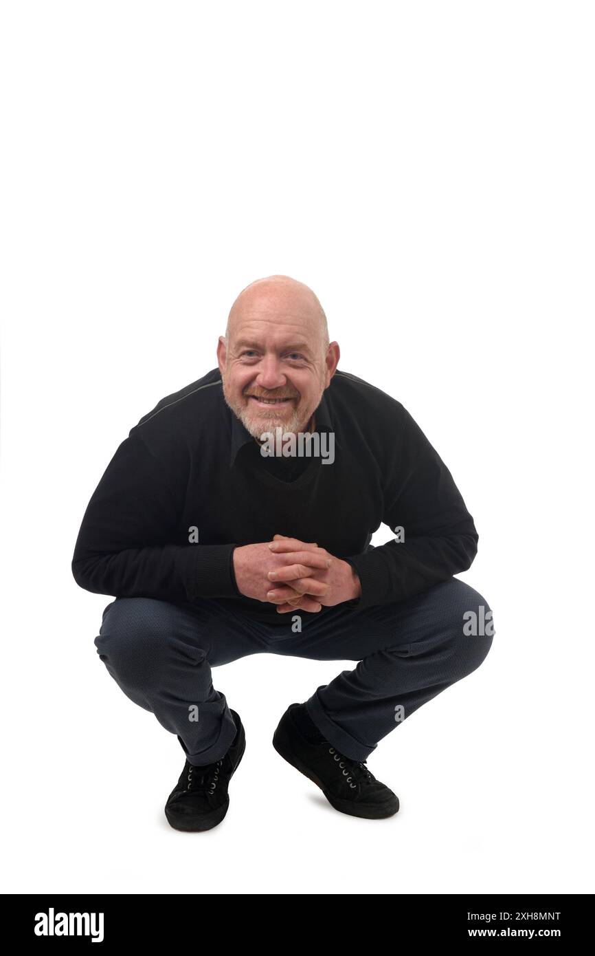 crouching man looking at camera on white background Stock Photo - Alamy