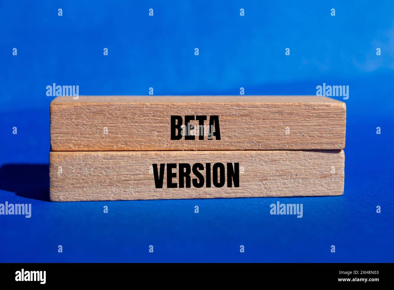 Beta version message written on wooden blocks with blue background ...