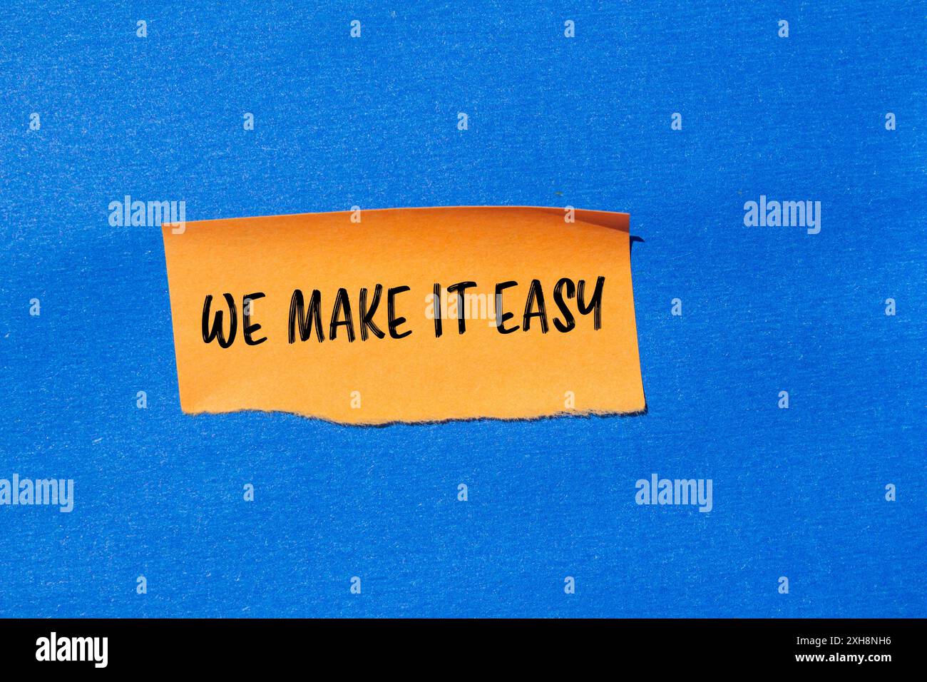 We make it easy message written on ripped torn orange paper piece with ...