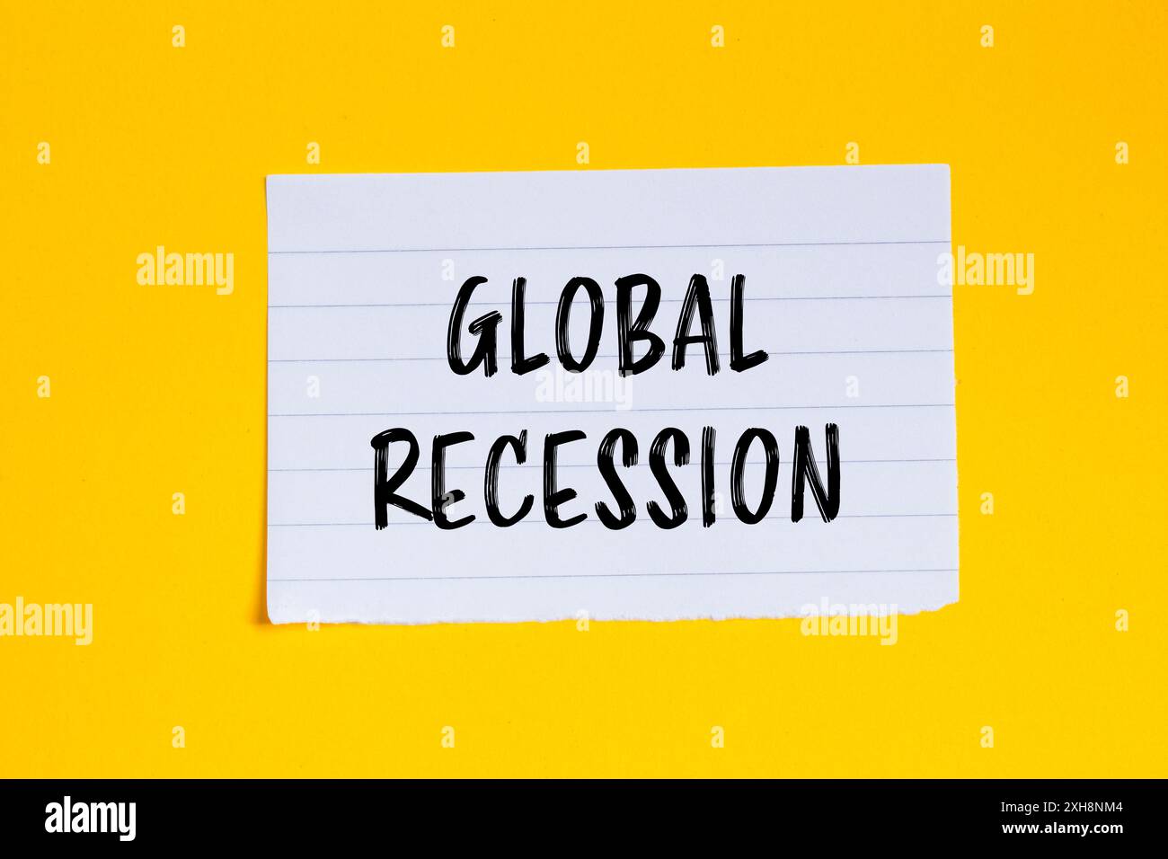 Global recession message written on ripped white paper piece with ...