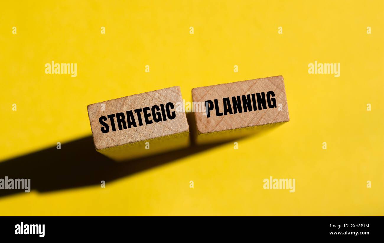 Strategic planning message written on wooden blocks with yellow ...