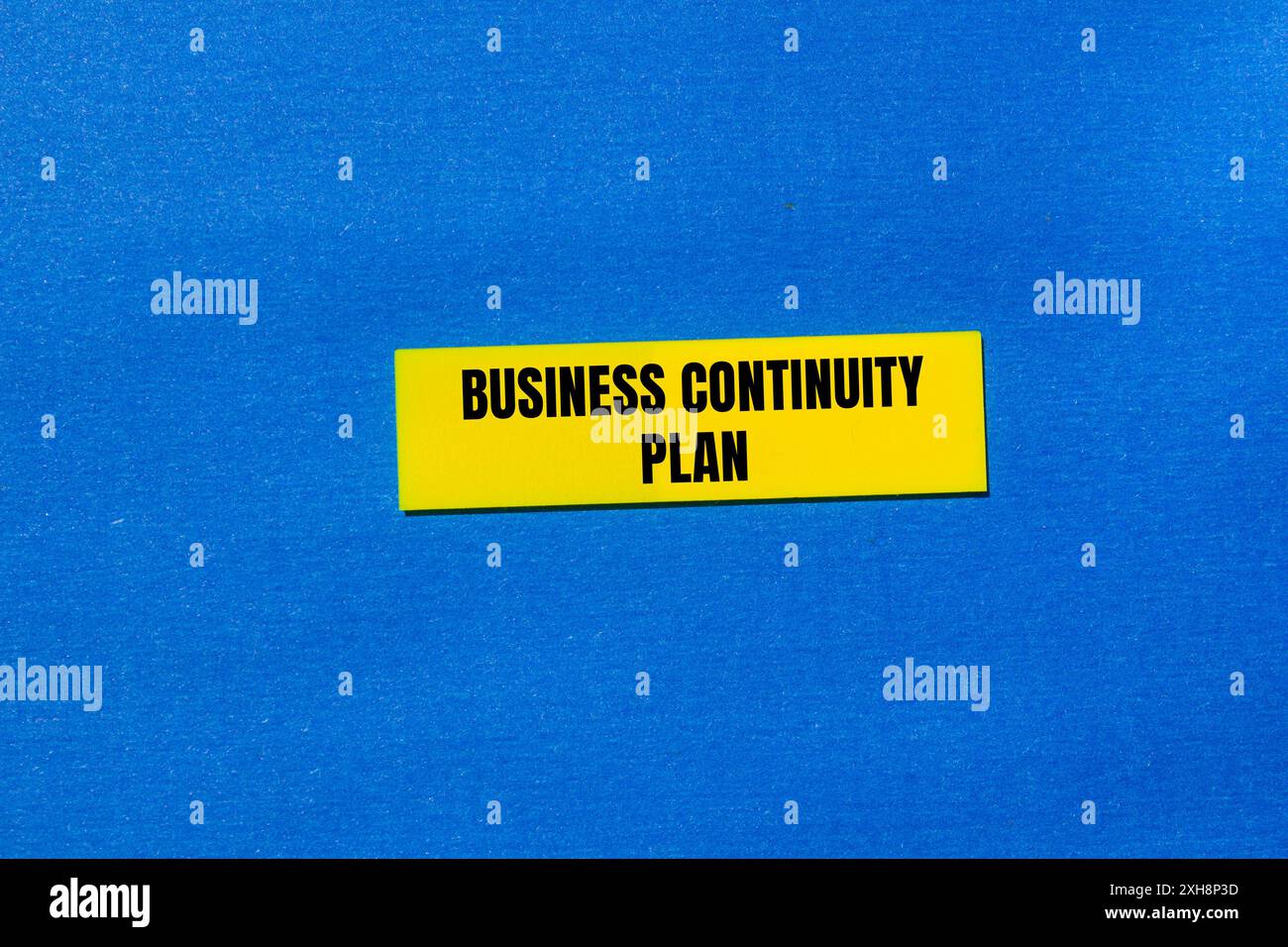 Business continuity plan message written on yellow paper with blue ...