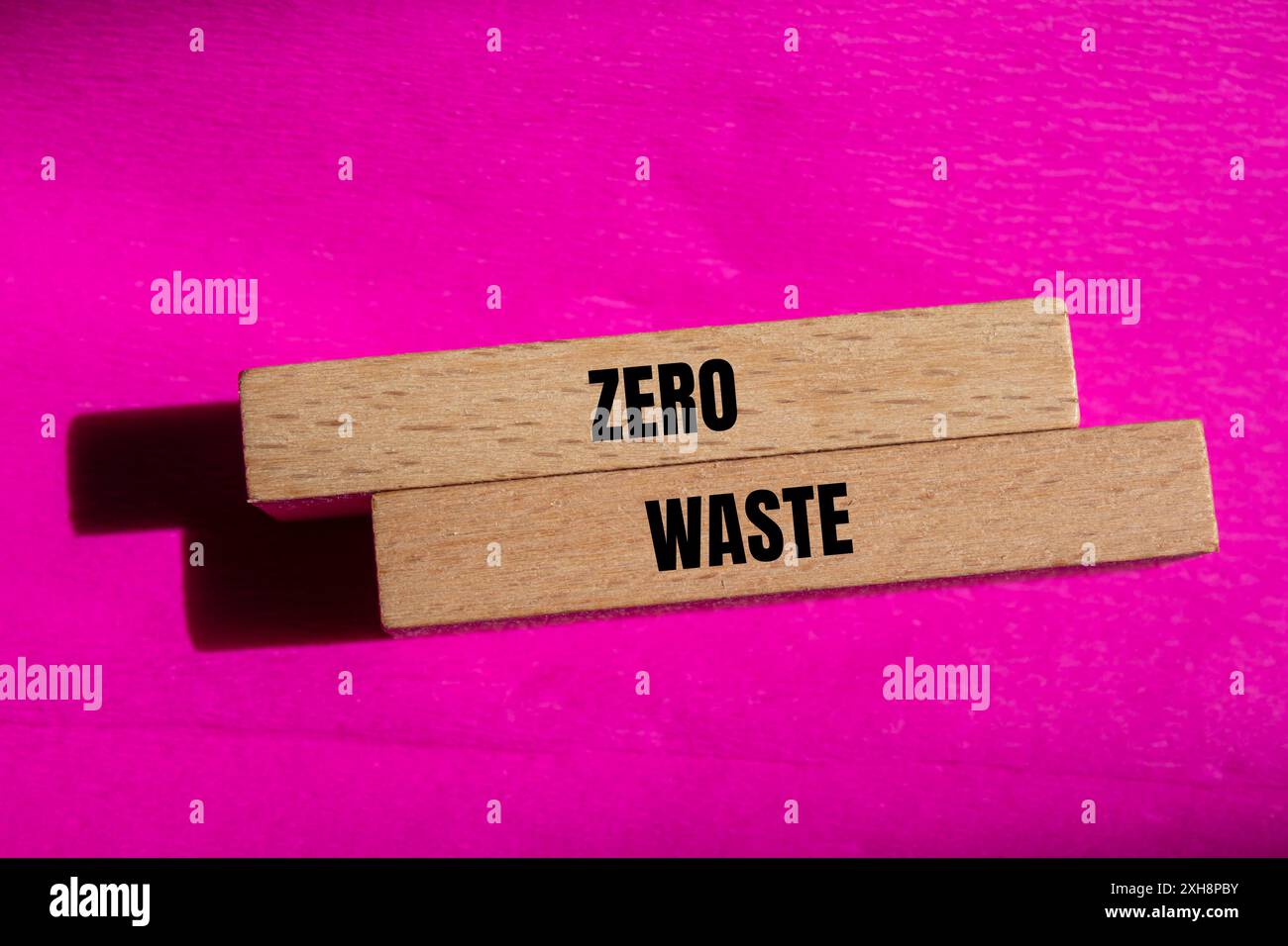 Zero waste message written on wooden blocks with pink background. Conceptual zero waste symbol ...