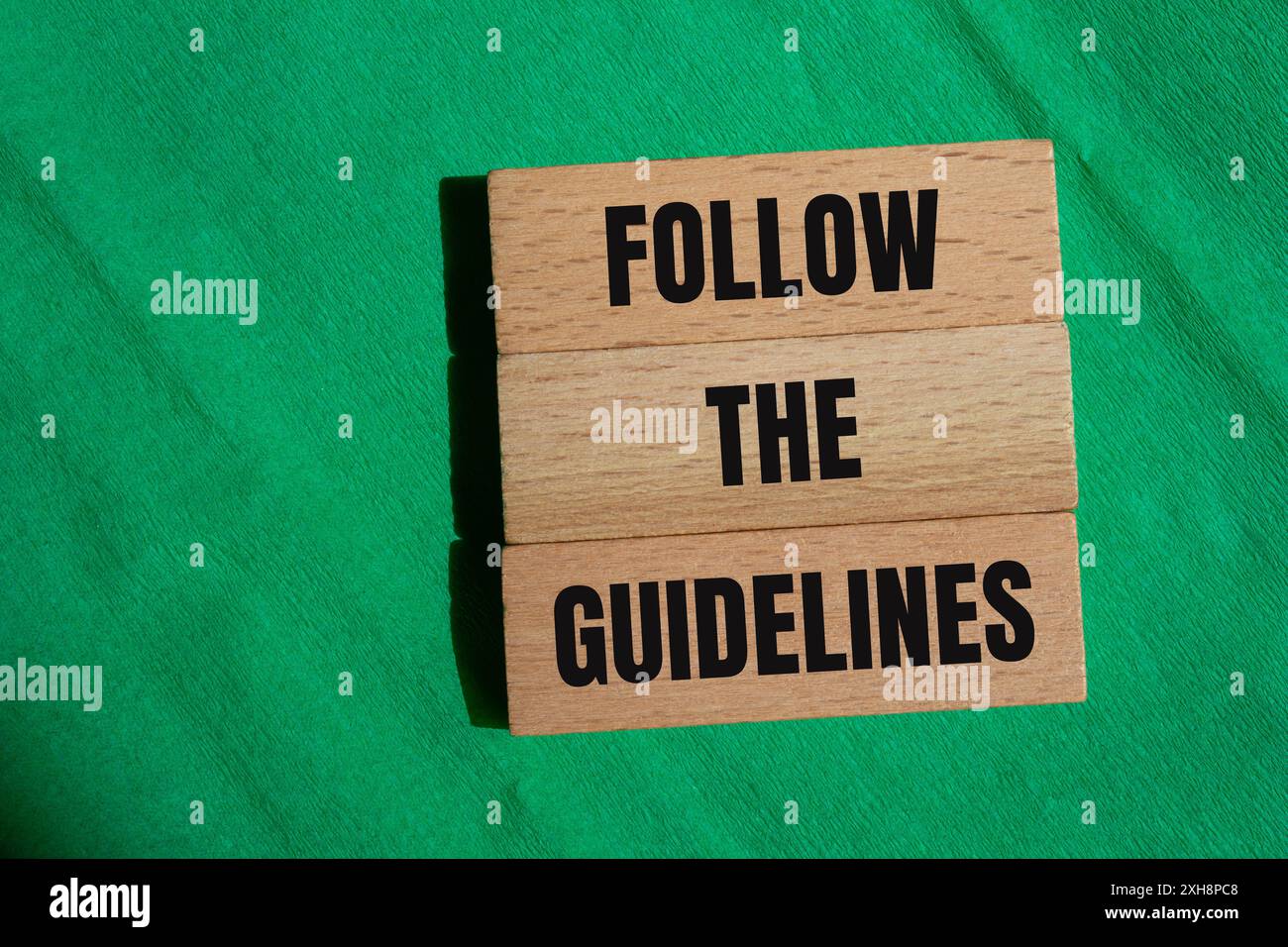 Follow the guidelines words written on wooden blocks with green ...