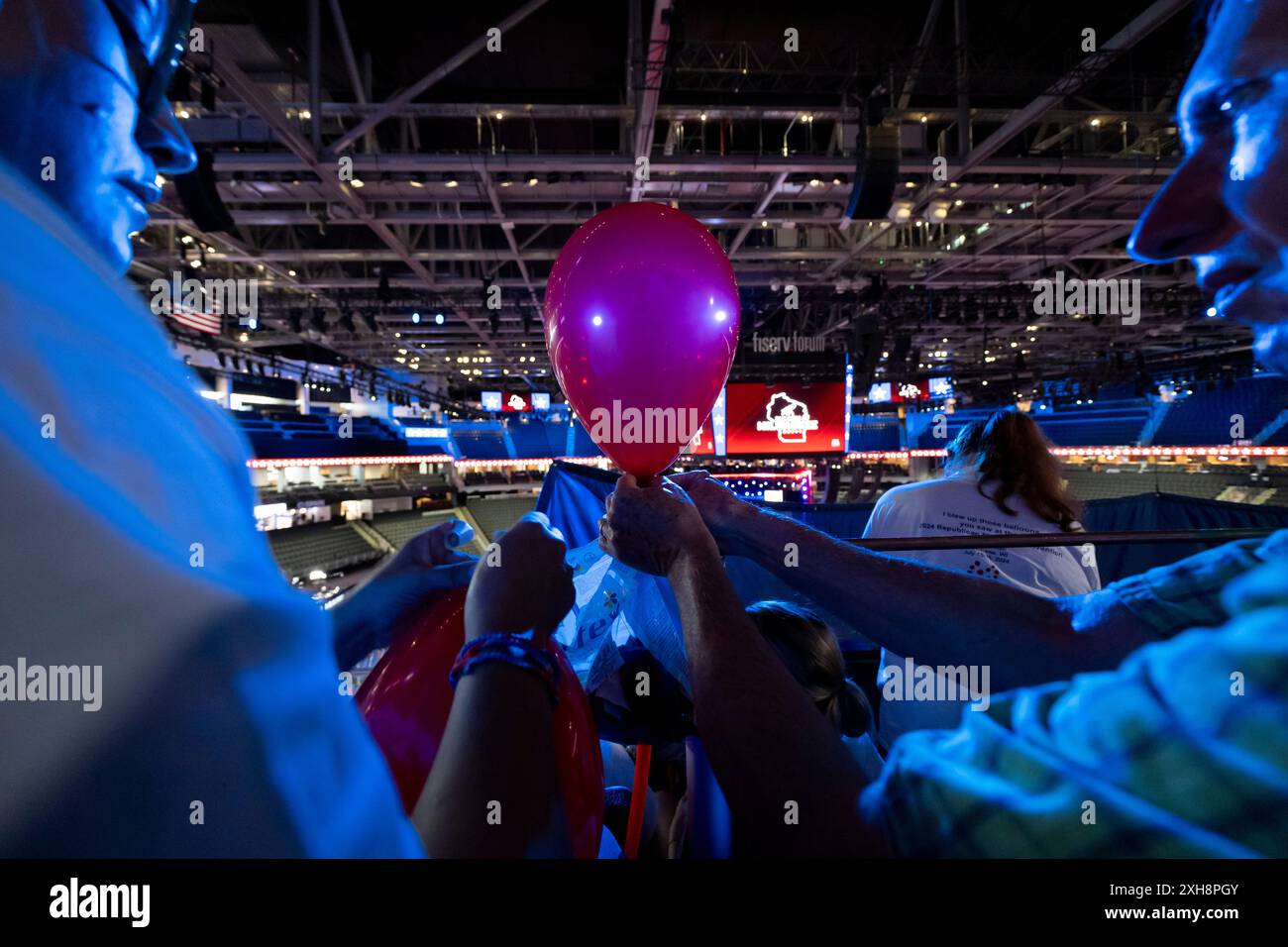 Volunteers inflate balloons in the Fiserv Forum ahead of the 2024 ...