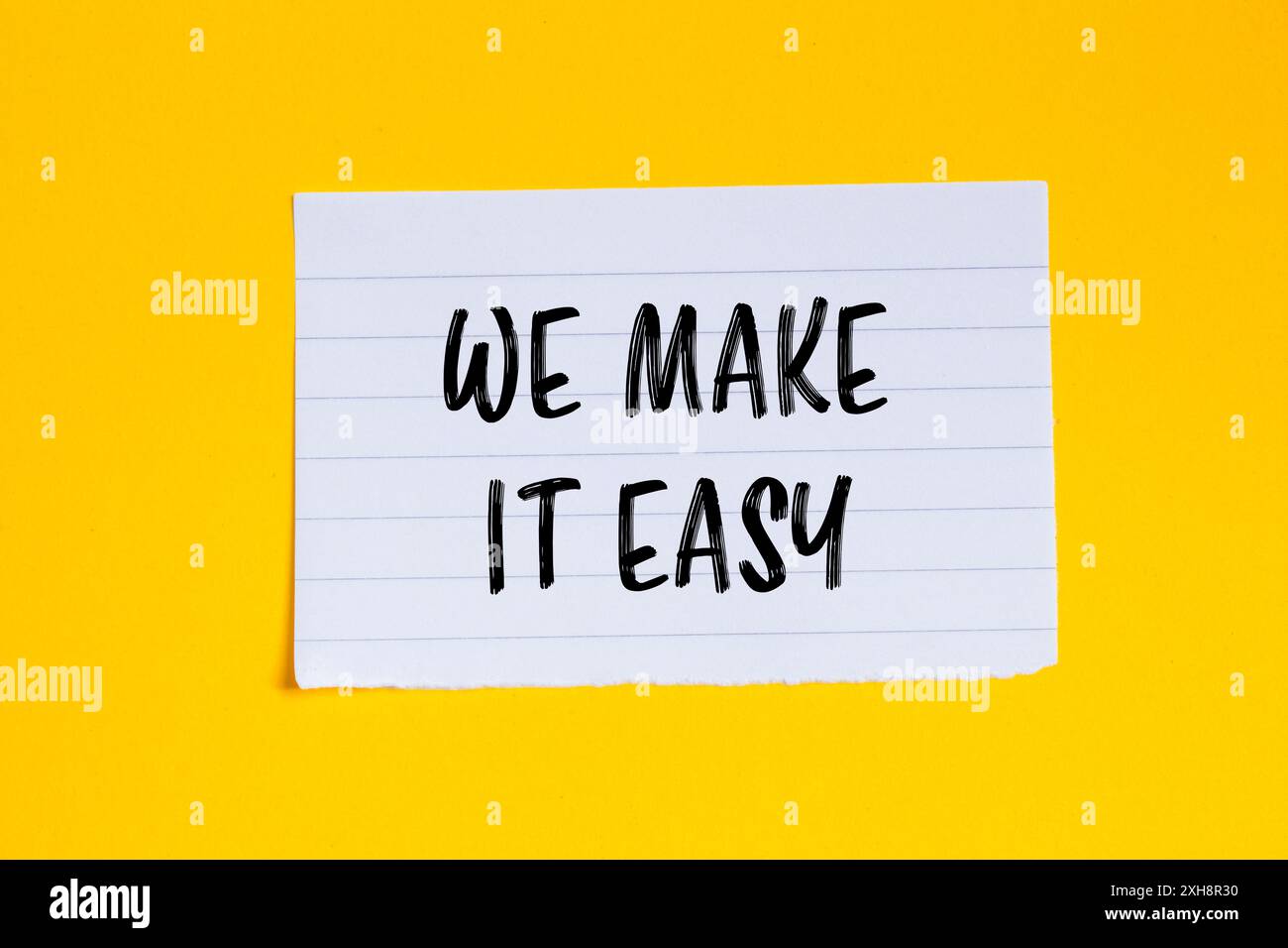 We make it easy message written on ripped white paper piece with yellow ...