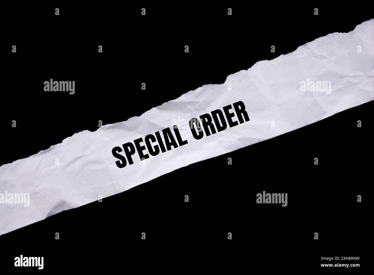 Special order message written on ripped torn white paper with black ...