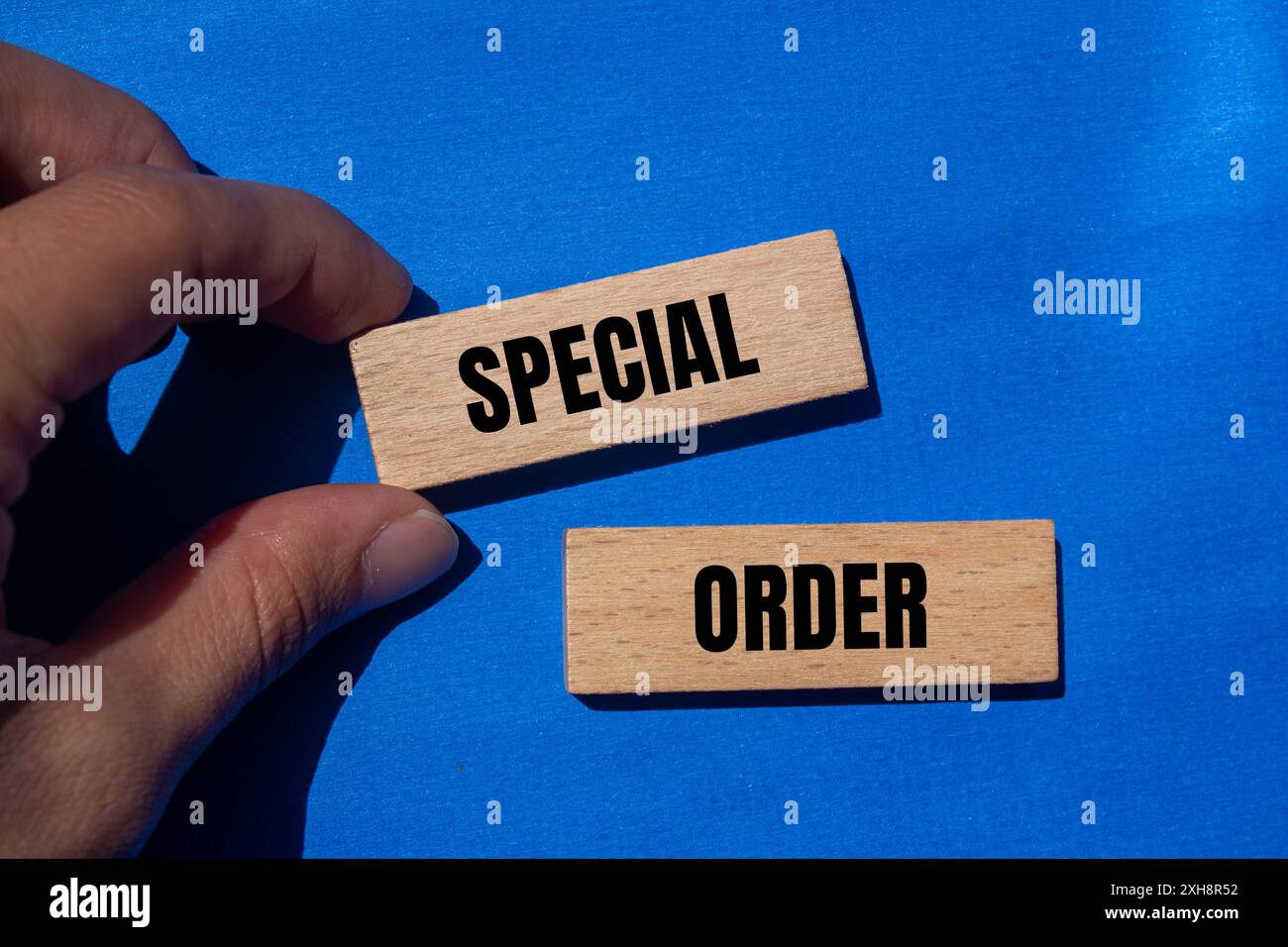 Special order message written on wooden blocks with blue background ...