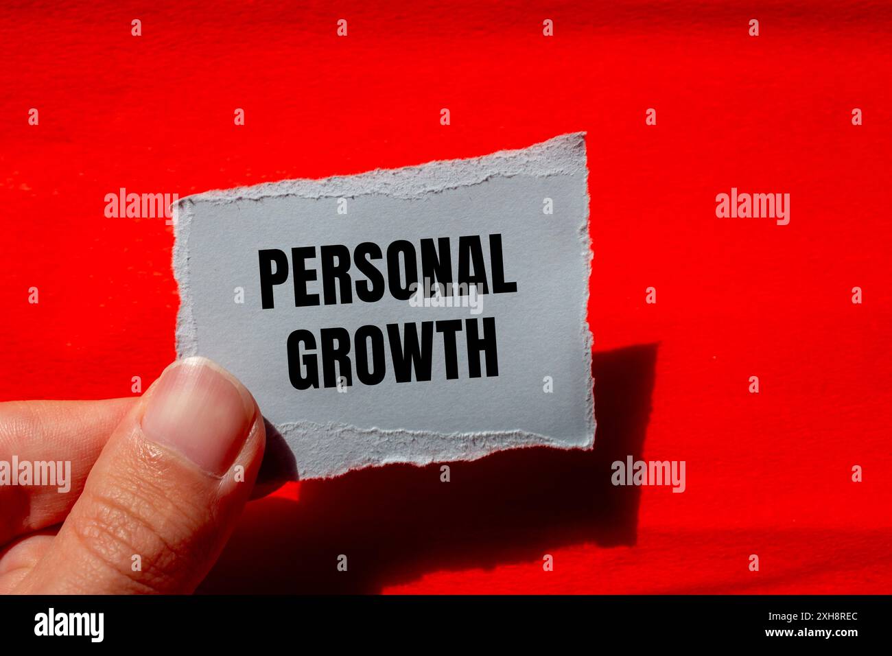 Personal growth message written on ripped paper piece with red ...