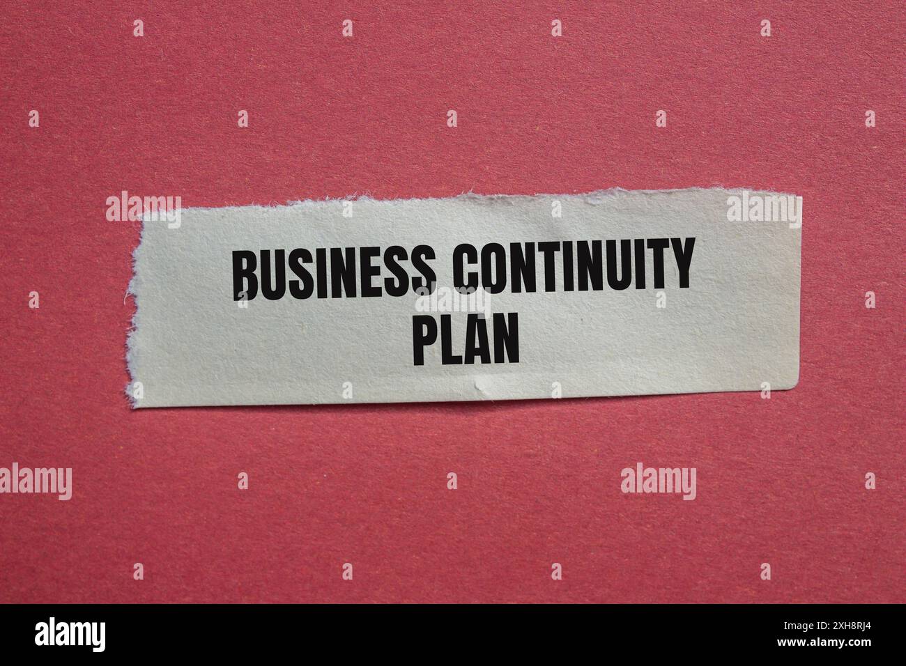 Business continuity plan message written on ripped paper with red ...