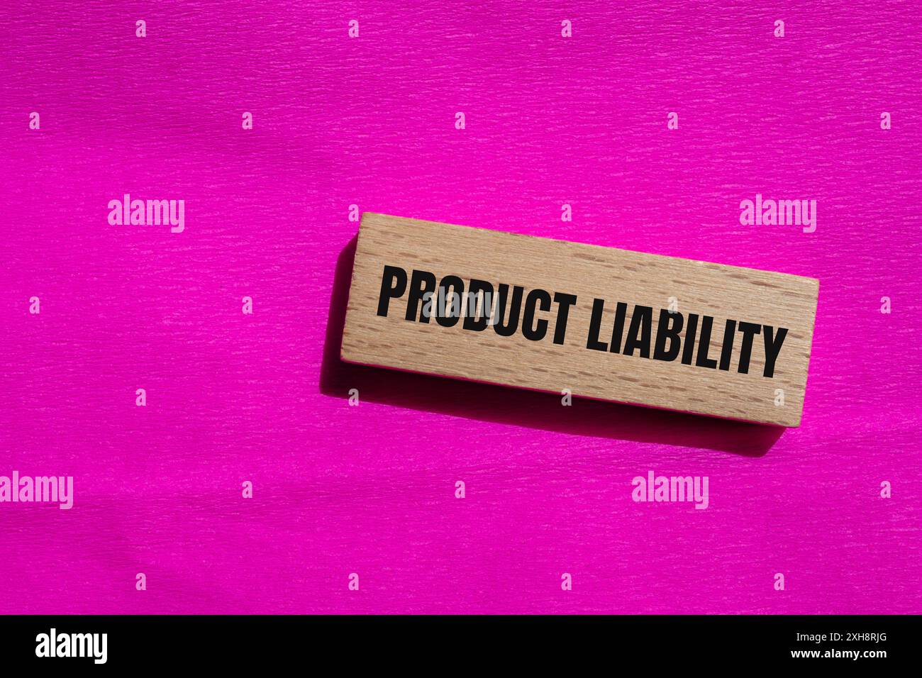 Product liability words written on wooden block with pink background ...