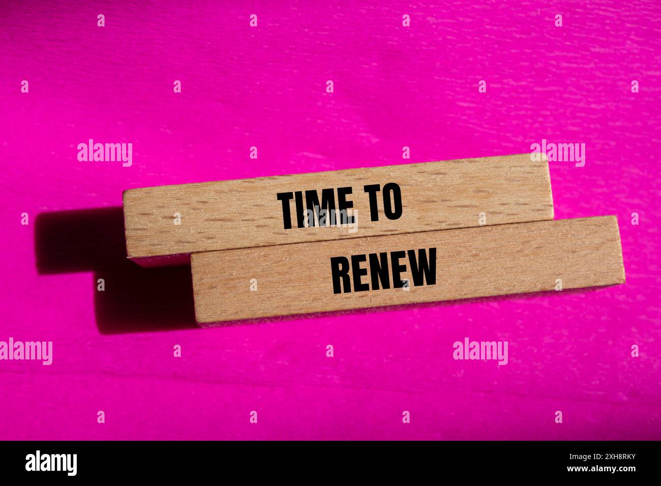 Time to renew message written on wooden blocks with pink background ...