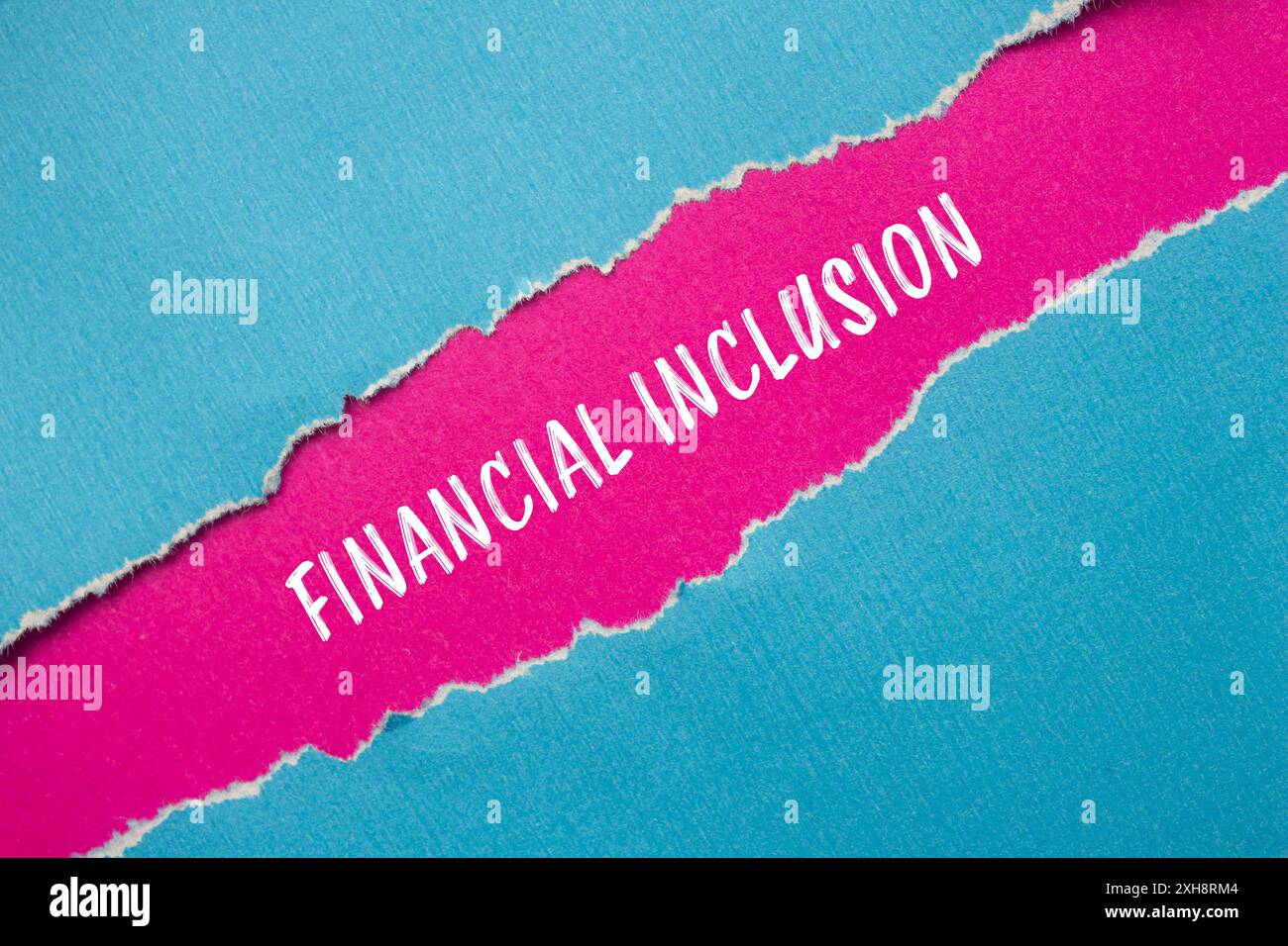 Financial inclusion message written on ripped blue paper with pink ...